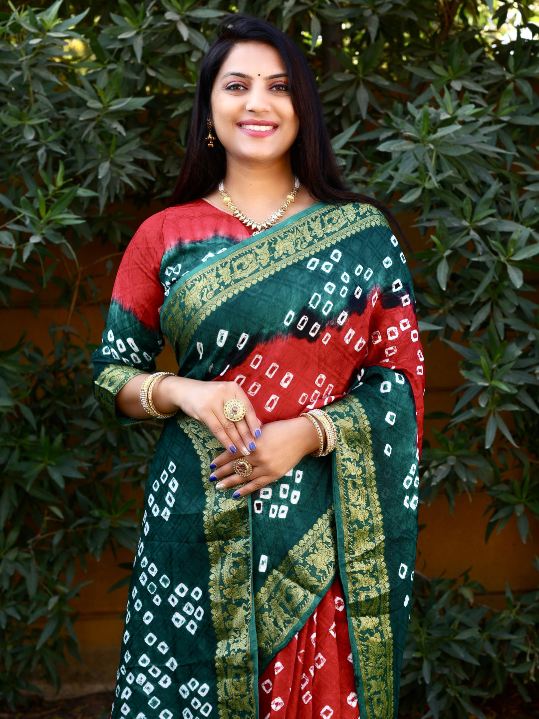 Red and green color bandhej silk saree with zari weaving work